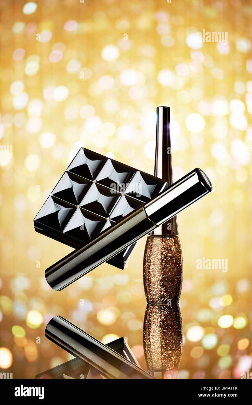 make up products with reflection with a gold background Stock Photo - Alamy