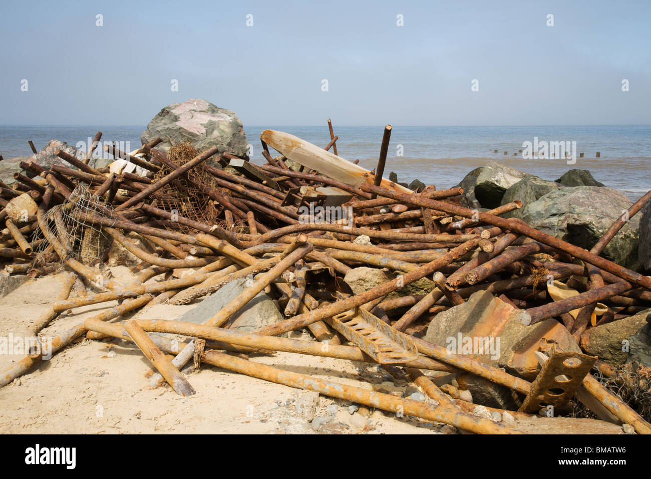 A pile of twisted rusty metal on Happisburgh seashore, Norfolk, England ...