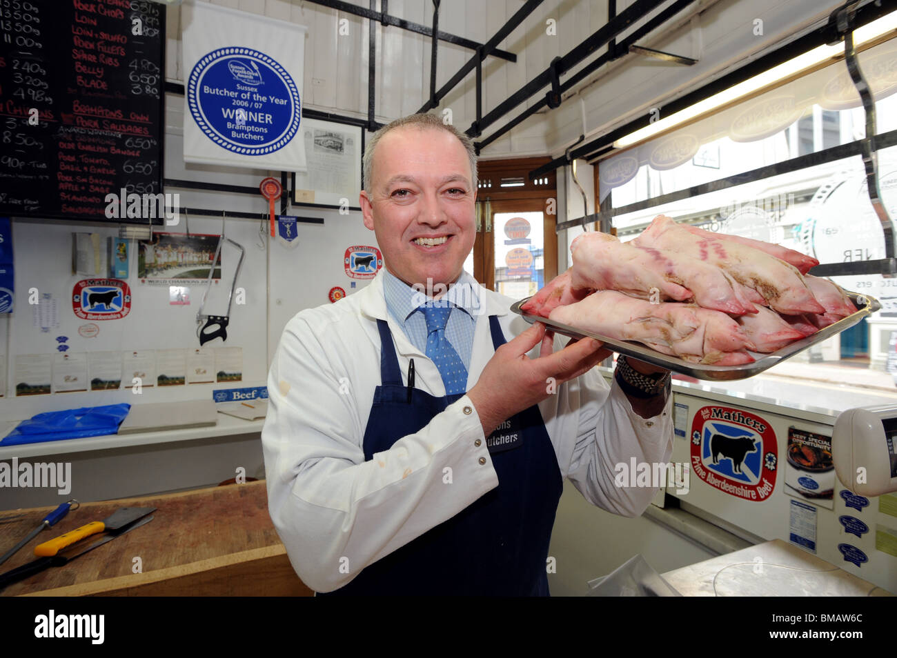 Butcher Paul williams with pigs trotters Stock Photo - Alamy