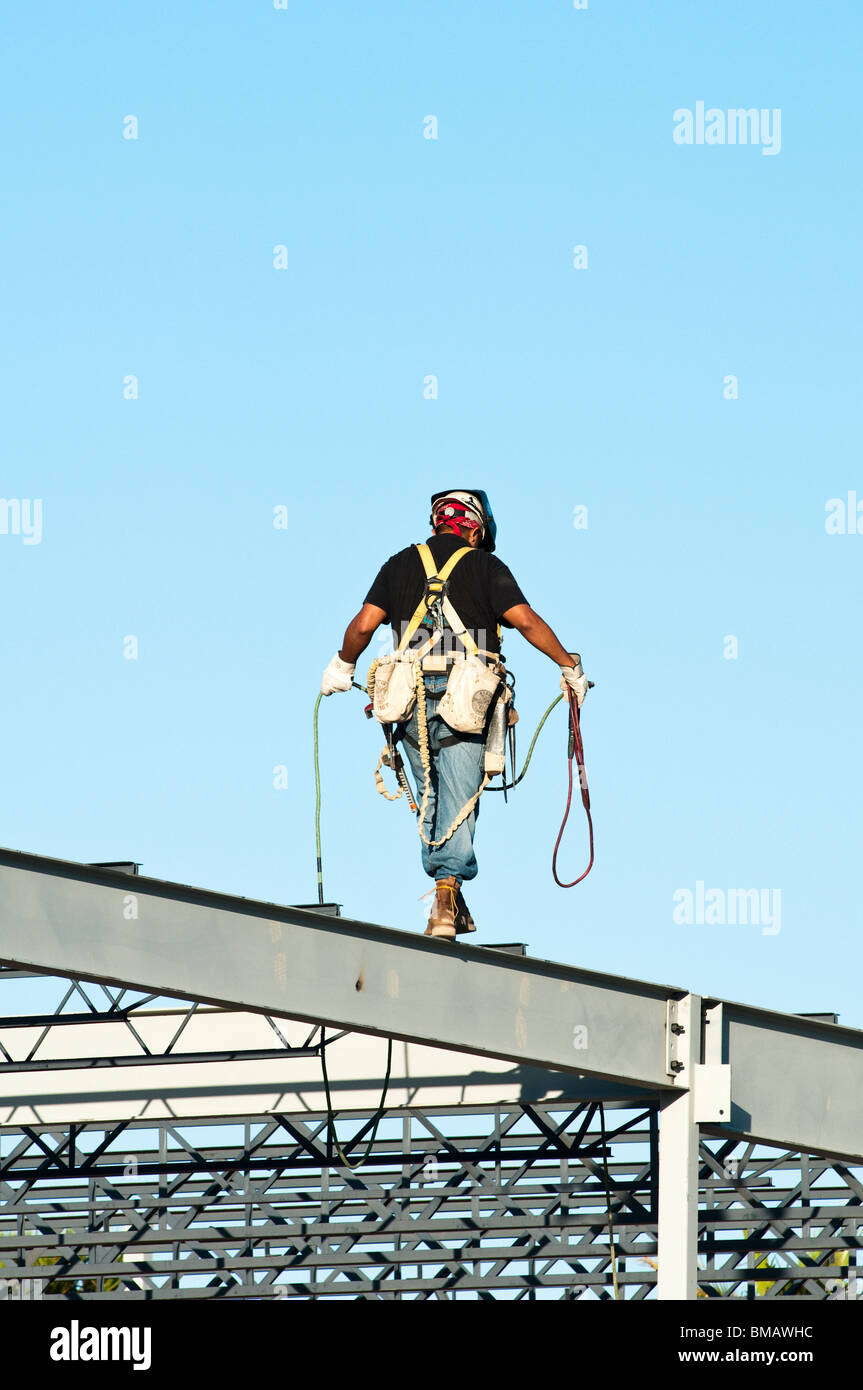 steelworkers erect the structural steel framework for a commercial ...