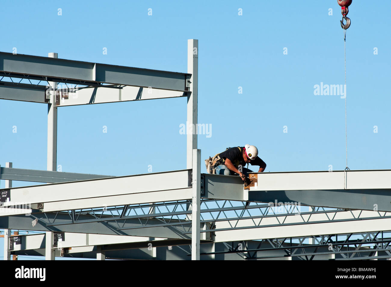 steelworkers erect the structural steel framework for a commercial ...
