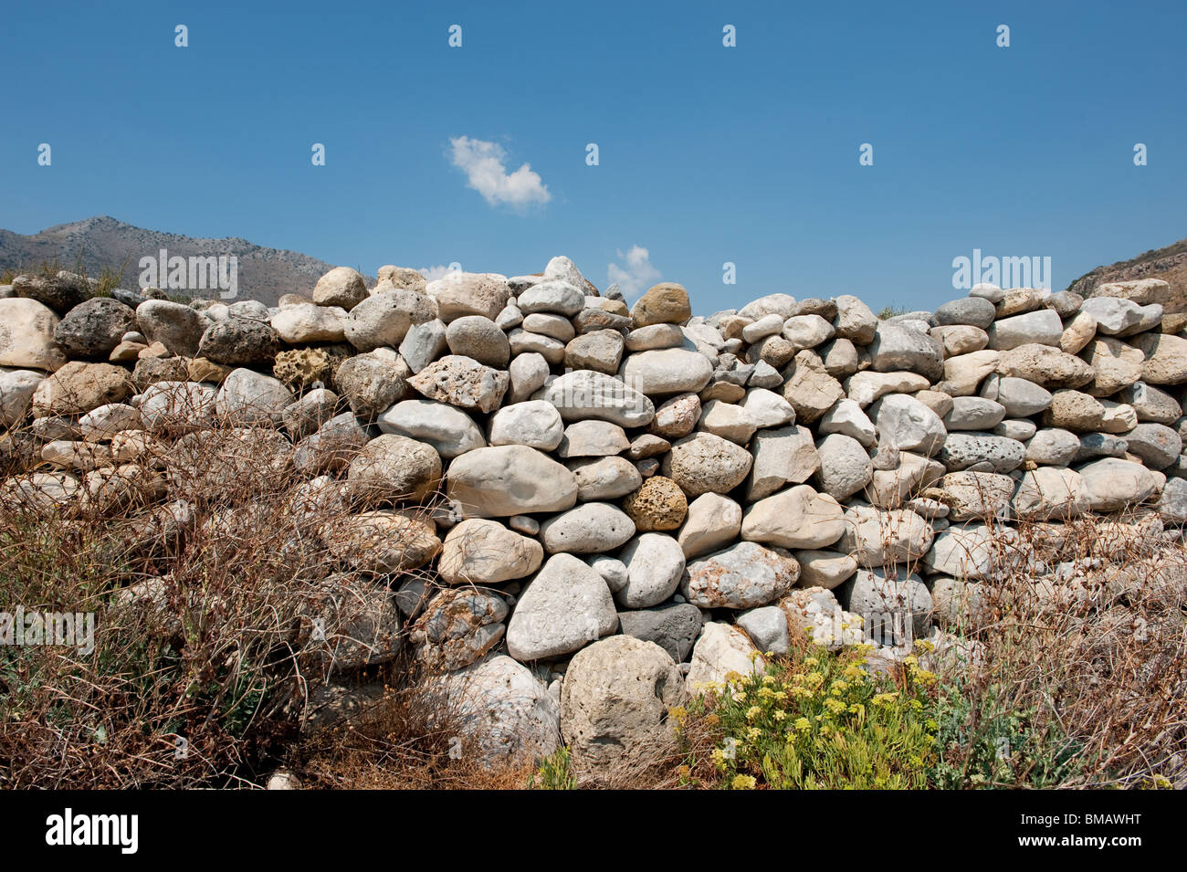 Stone wall made from white pebbles in Greek nature Stock Photo - Alamy