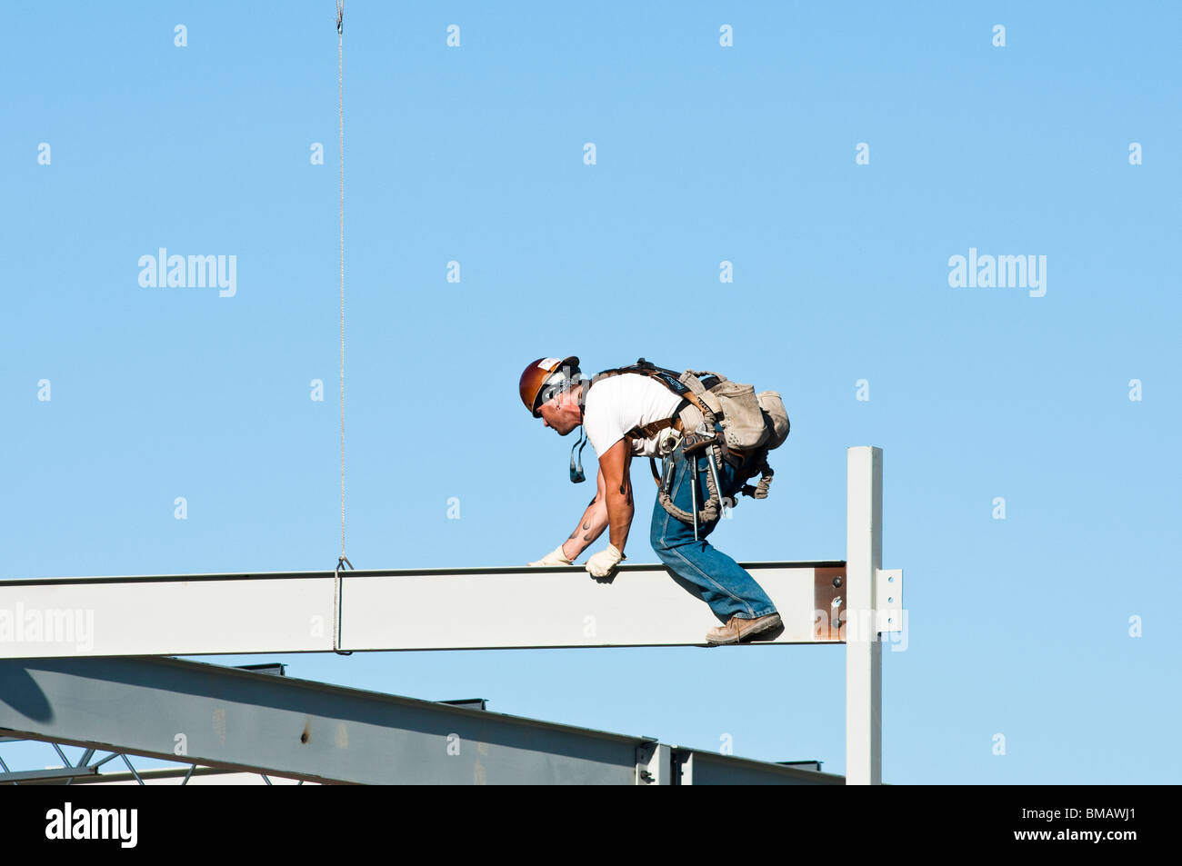 steelworkers erect the structural steel framework for a commercial ...