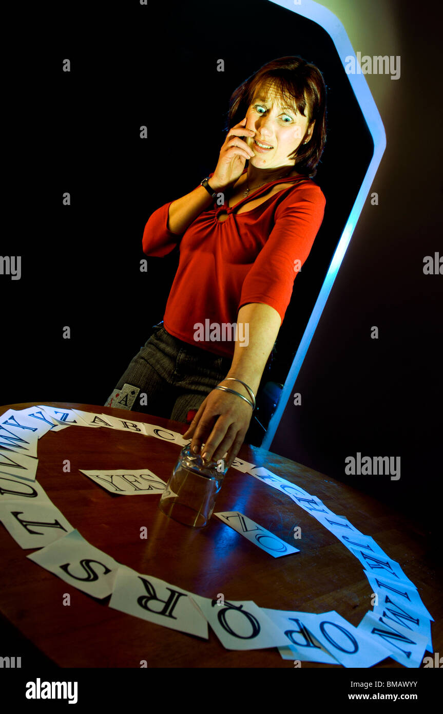 A woman shocked trying to use a ouiji board to contact the dead Stock ...