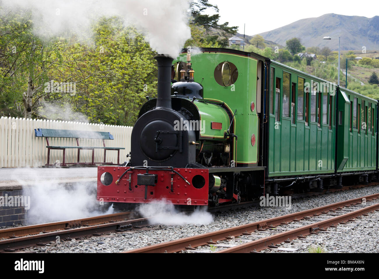 small mountain steam train at a railway station Stock Photo - Alamy