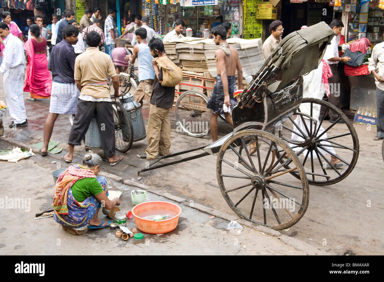 Street scene ; hand rickshaw puller pulling with passenger and load on ...