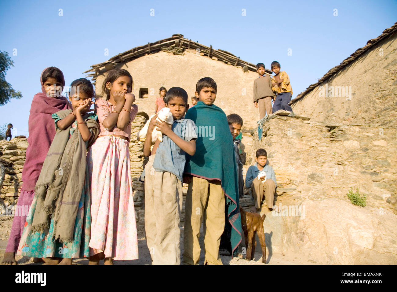 Children standing outside of hut ; rural activity of Bheel tribal ...