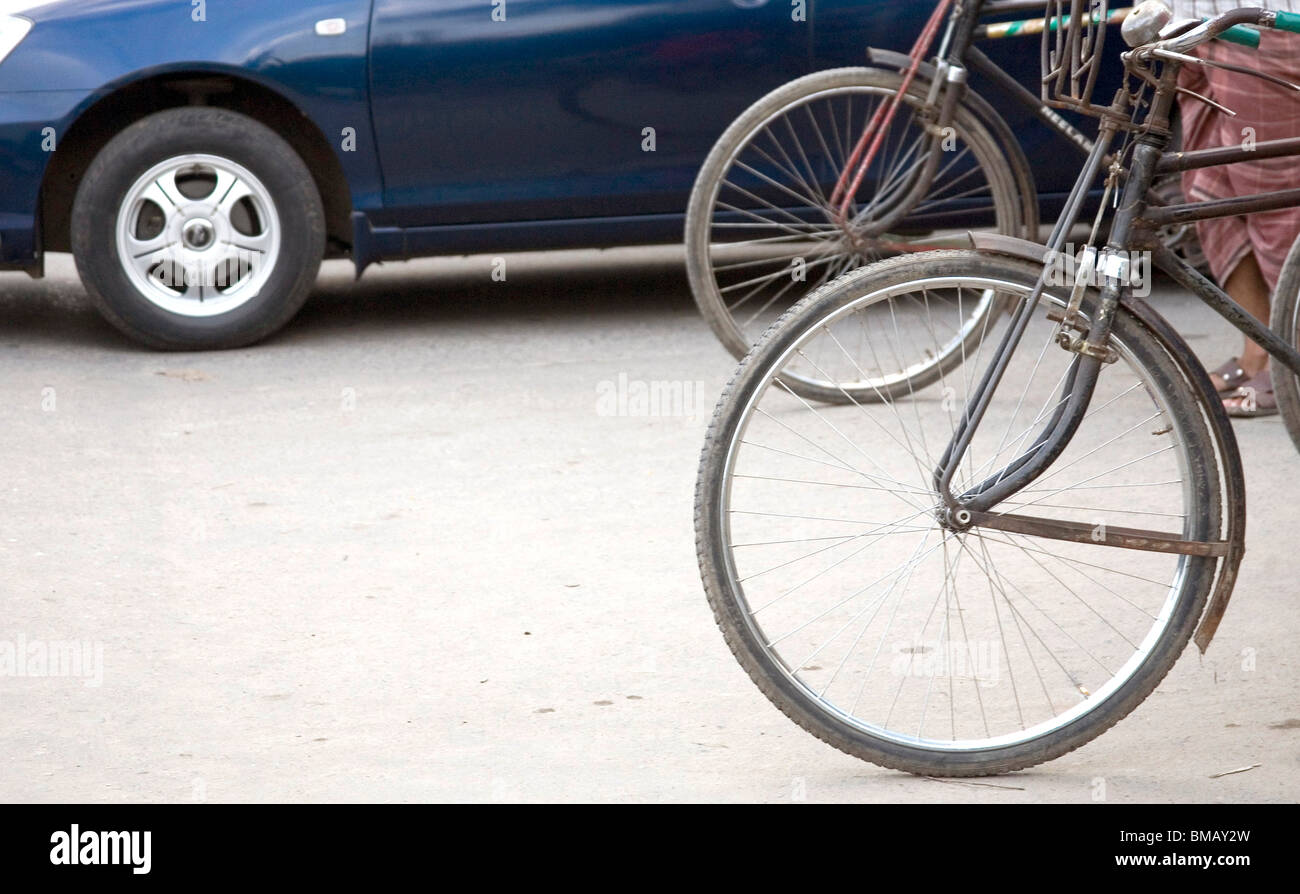 Street scene ; wheels of cycle rickshaw and car on Dhaka ; Bangladesh Stock Photo - Alamy