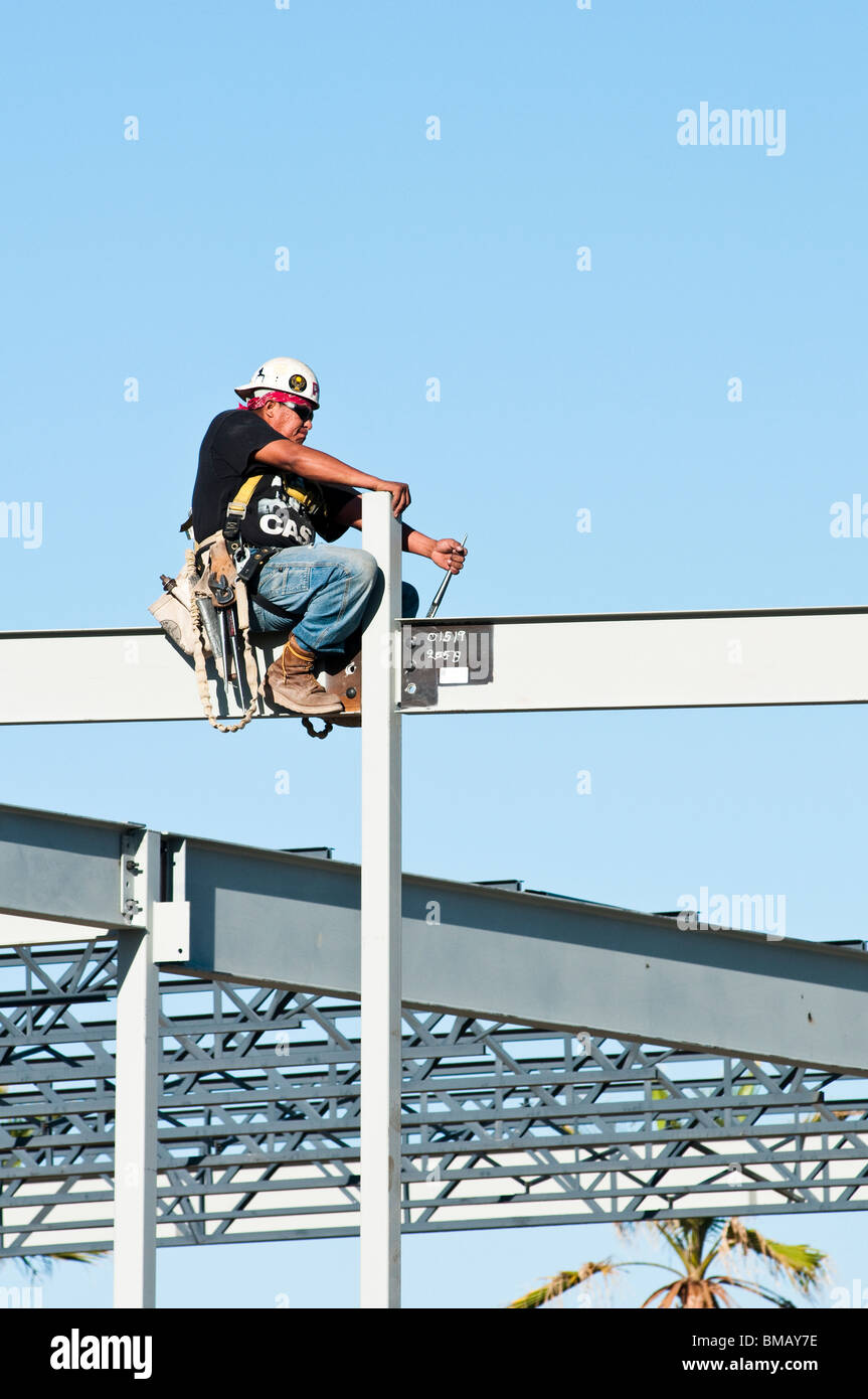steelworkers erect the structural steel framework for a commercial ...