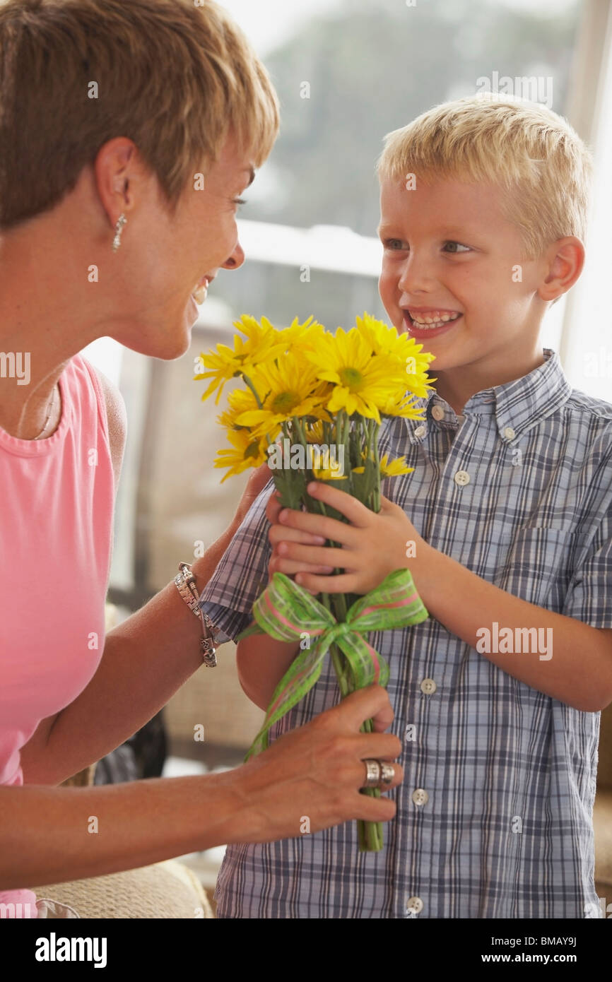 A Boy Giving Flowers To His Mother Stock Photo - Alamy