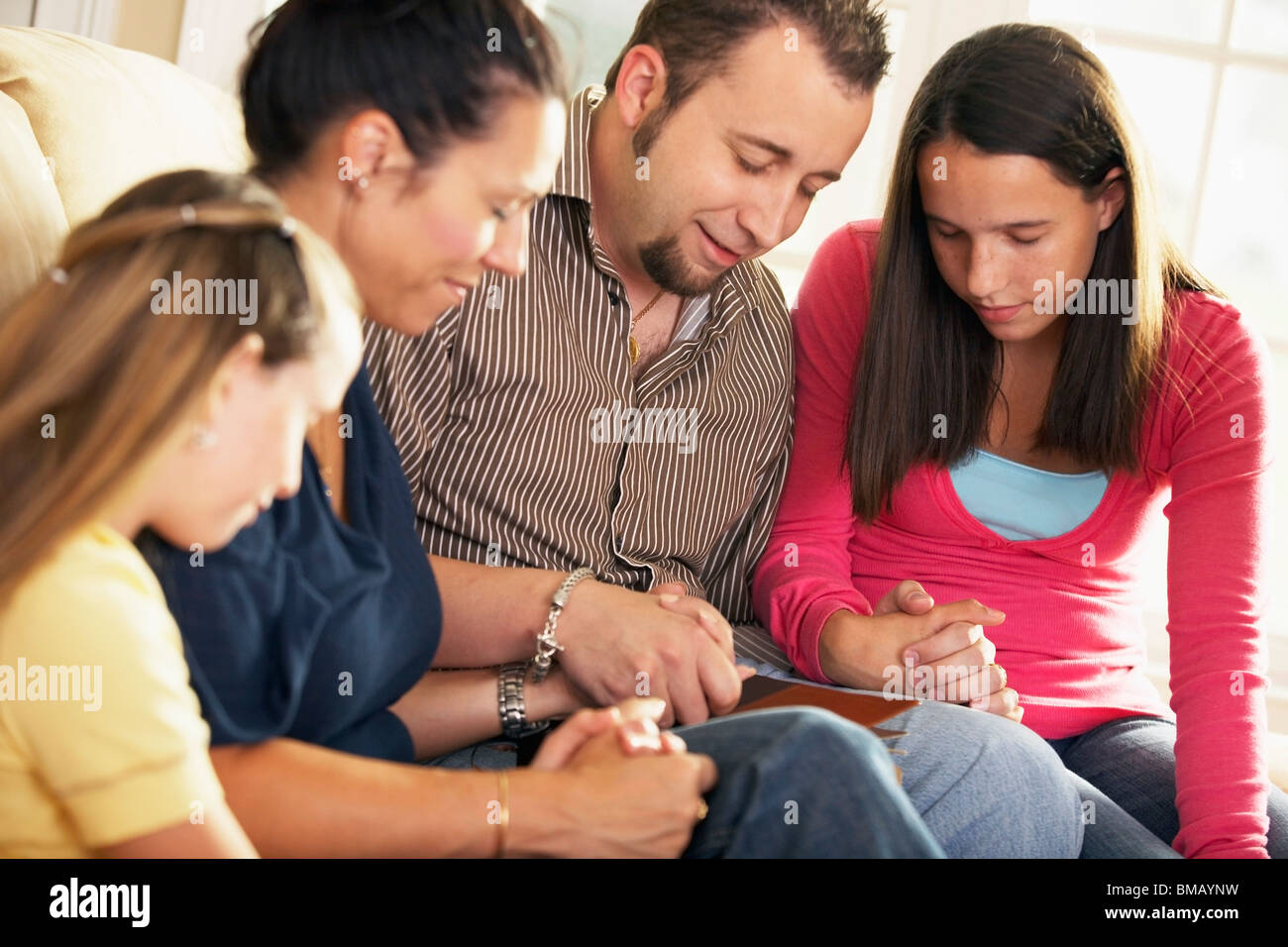 A Family Praying Together Stock Photo - Alamy