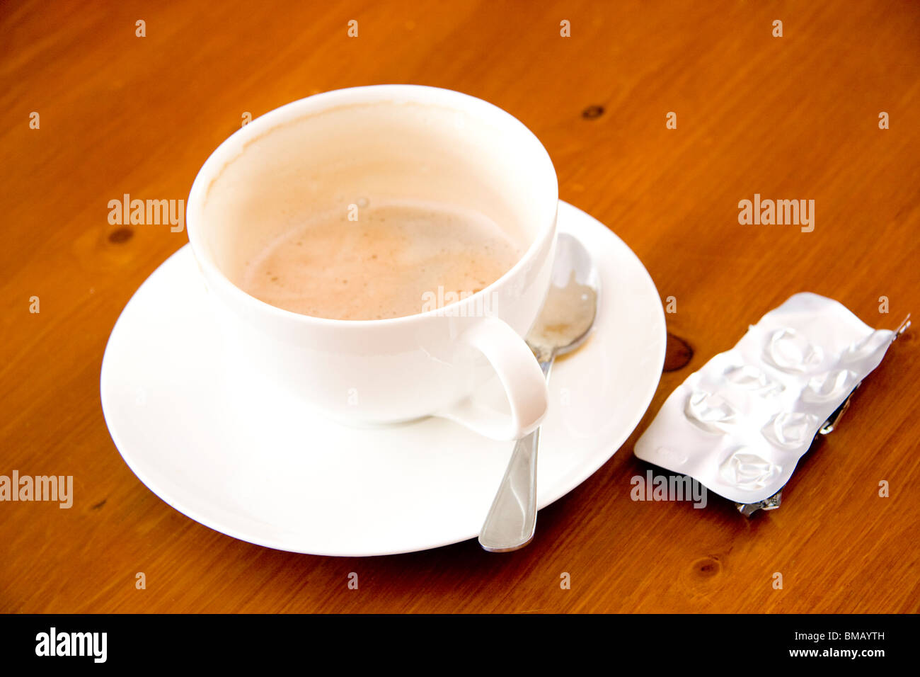 Coffee cup with a pack of tablets by the side Stock Photo - Alamy
