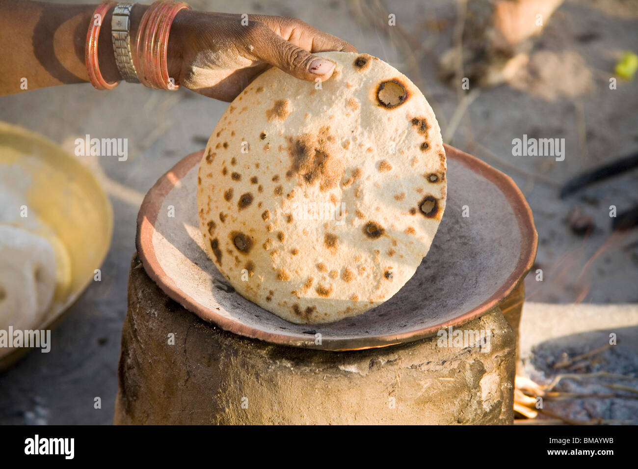 Wheat bread or roti being prepared ; semi urban village Dilwara ...