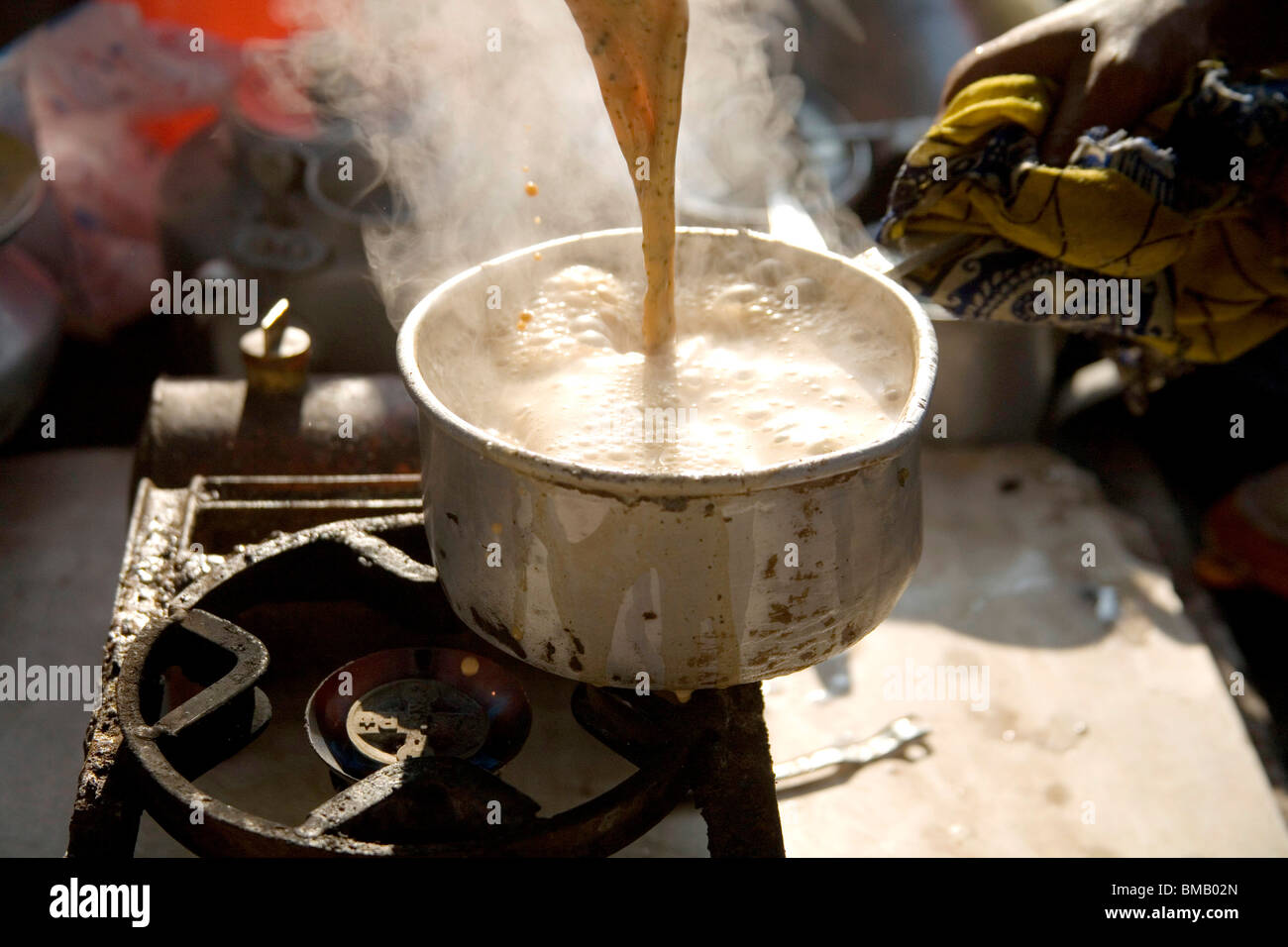 Pouring steam tea into teapot ; Calcutta now Kolkata ; West Bengal ...