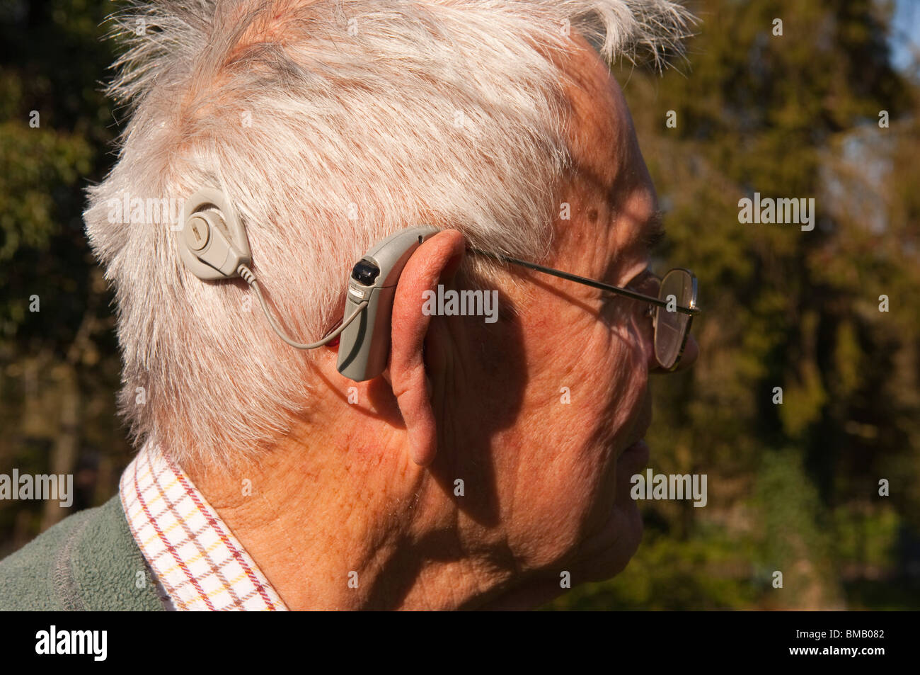 A MODEL RELEASED picture of an elderly man with his cochlear implant hearing aid in England ...