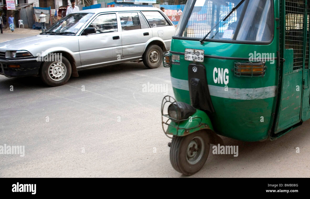 Street scene ; green auto rickshaw tempo and car on road traffic in ...