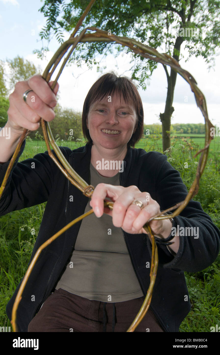 Woman weaving willow to make chain Stock Photo - Alamy