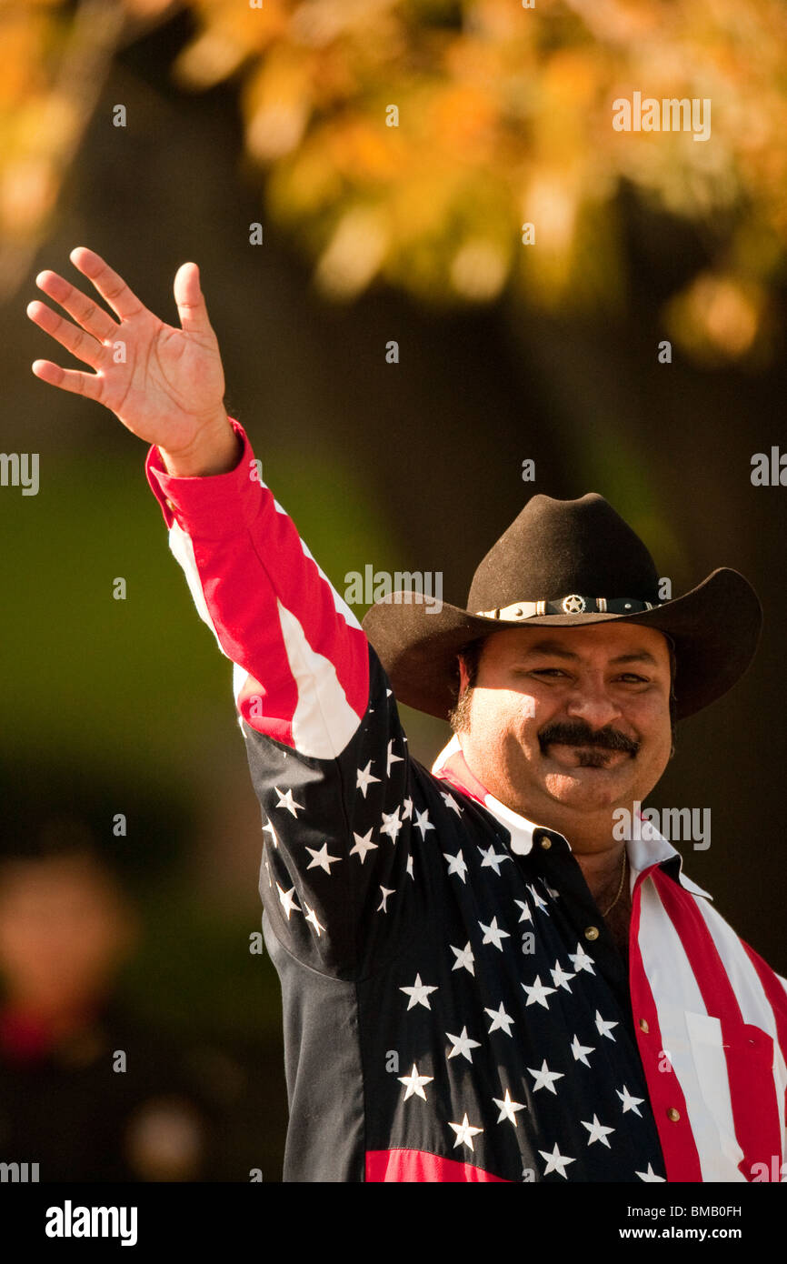 American war veteran waves to crowd from a float during a Veterans Day ...