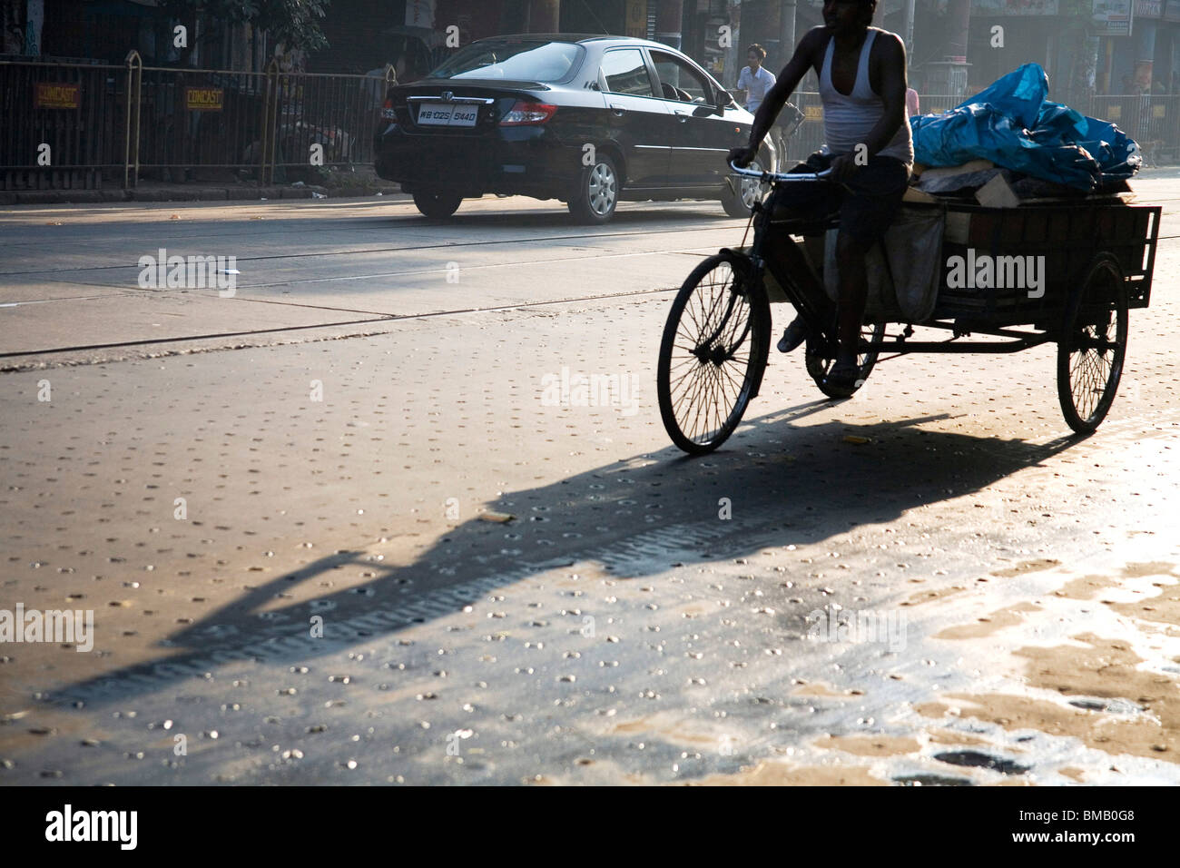 Man riding cycle rickshaw with luggage on road ; Calcutta now Kolkata ...