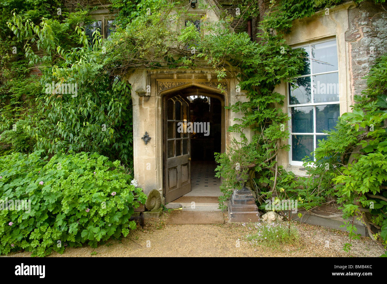Porch with open door; at Hanham Court House and garden. Climbers ...