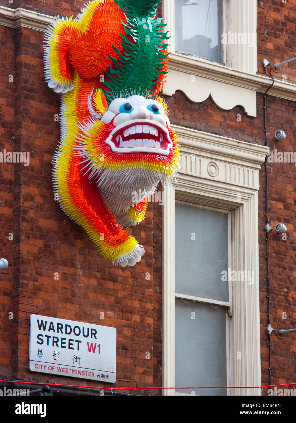 Chinese New Year dragon above street sign for Wardour Street in London ...