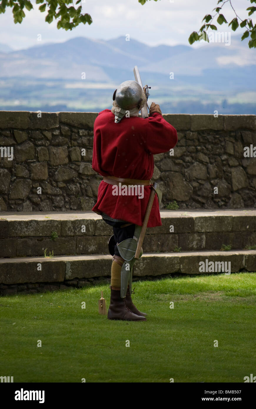 16th century Scottish Soldier of the Guard firing a fuselock rifle ...