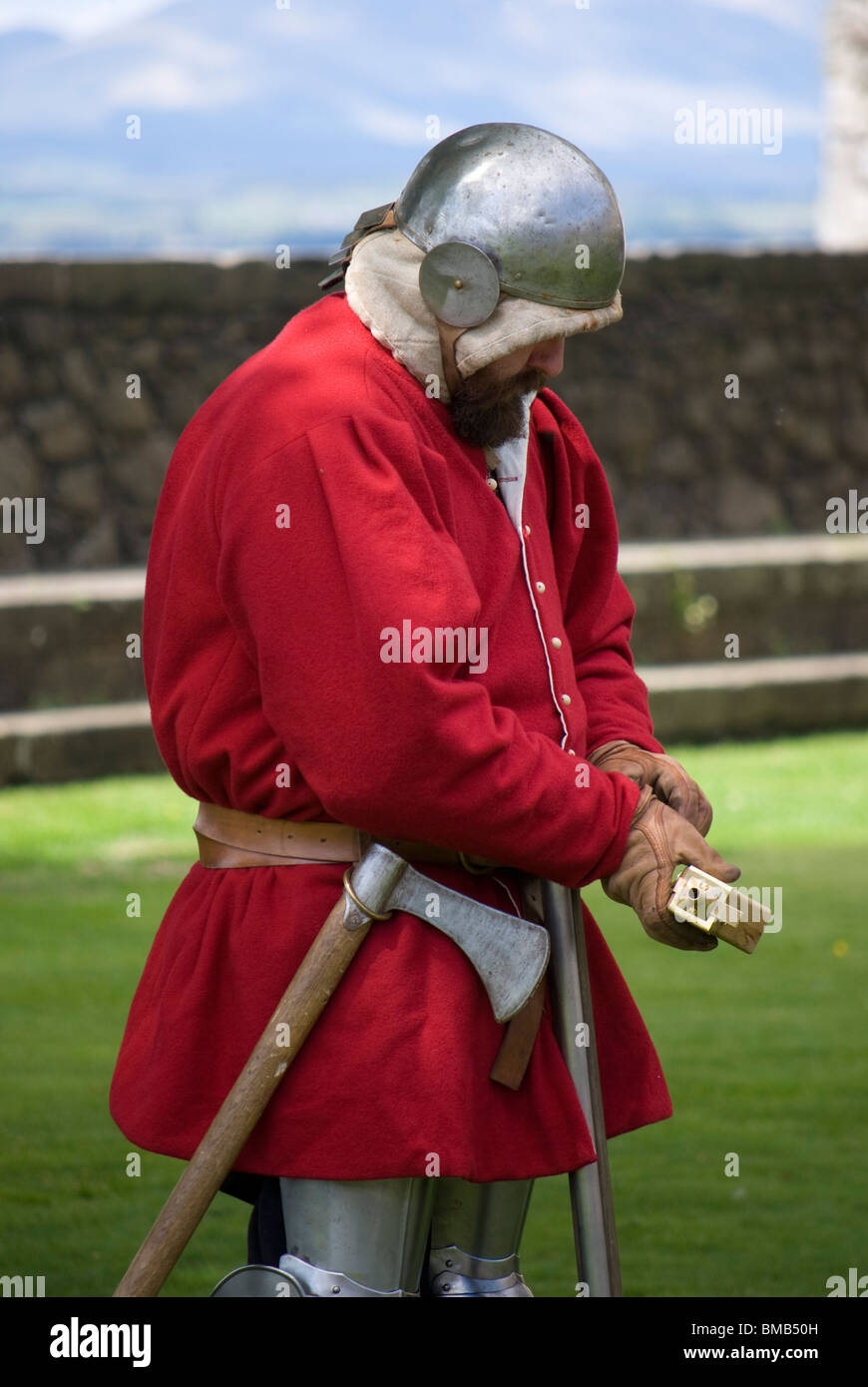 16th century Scottish Soldier of the Guard loading a fuselock rifle ...