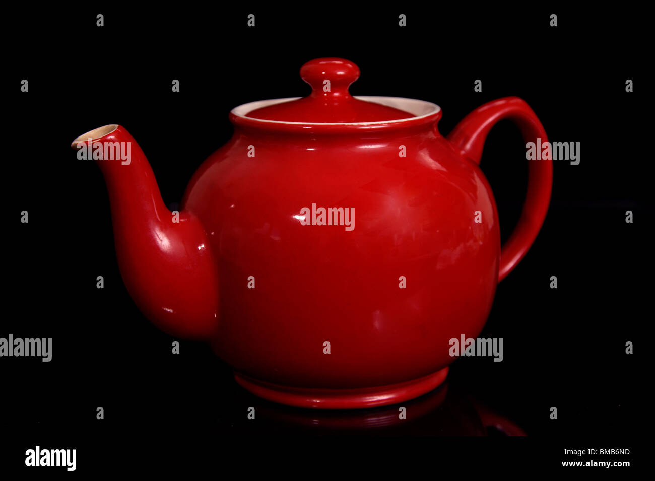 red teapot on black background Stock Photo - Alamy