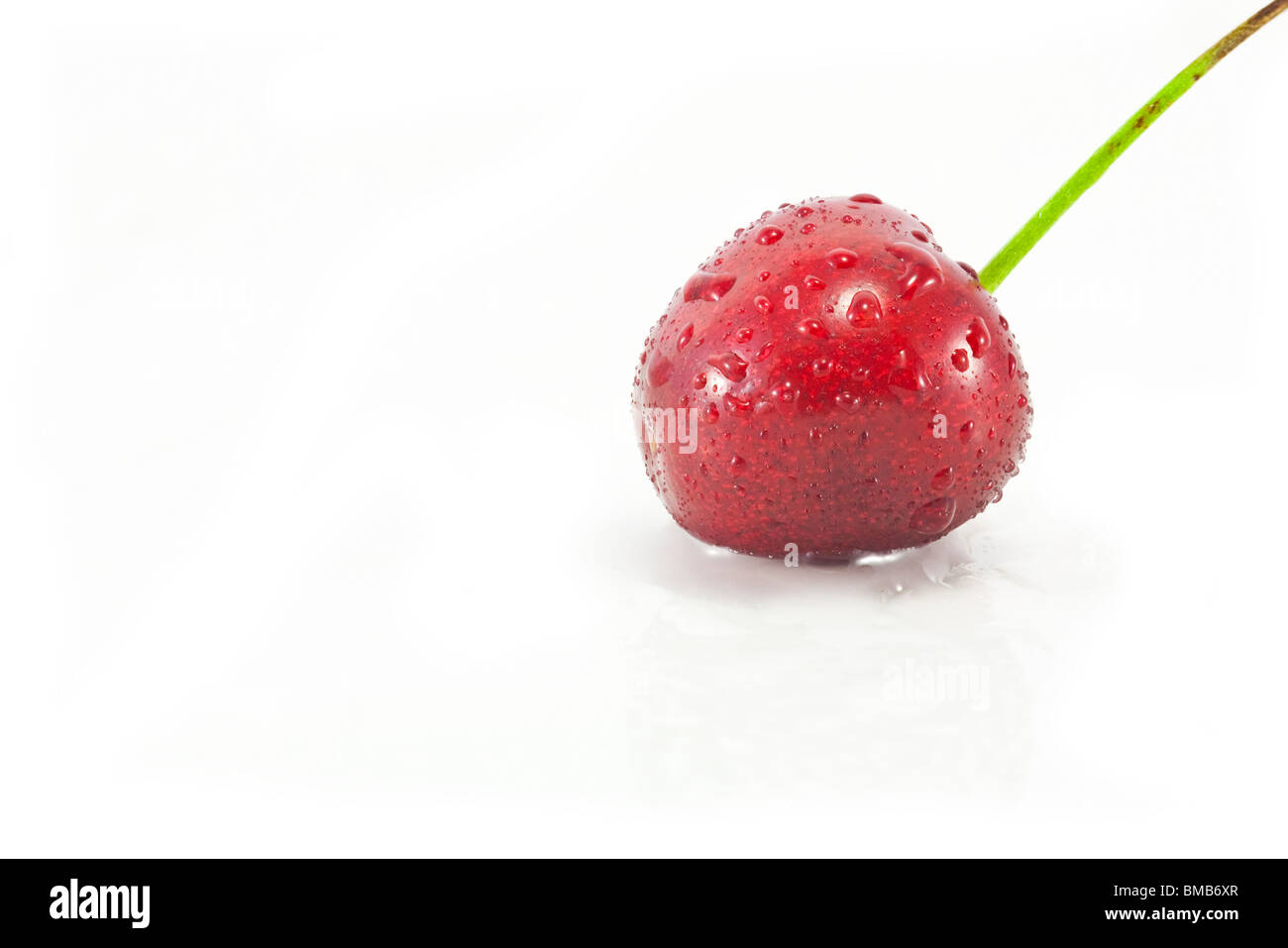 A single cherry isolated on a white background Stock Photo - Alamy