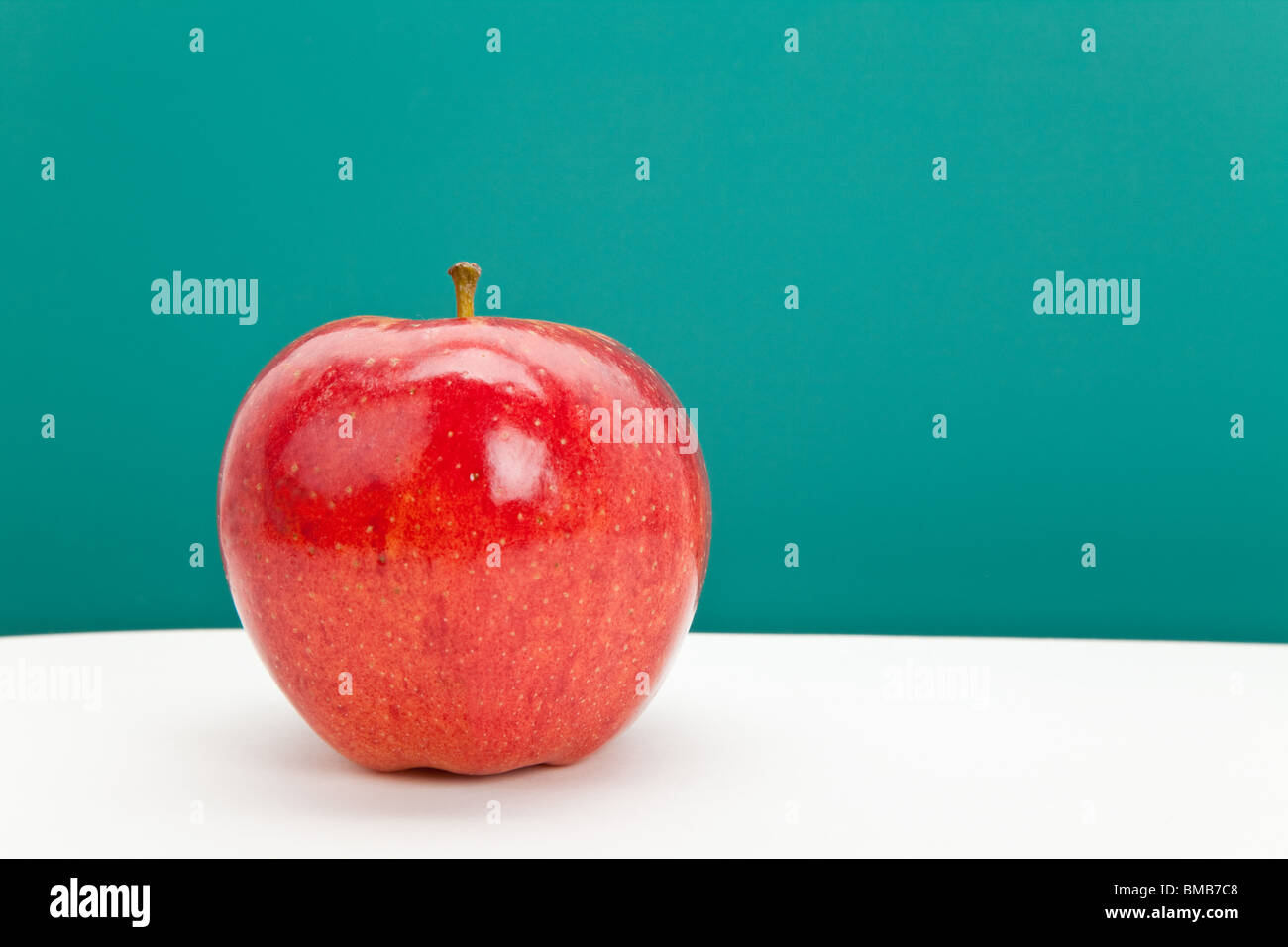 Red Apple with green background Stock Photo - Alamy
