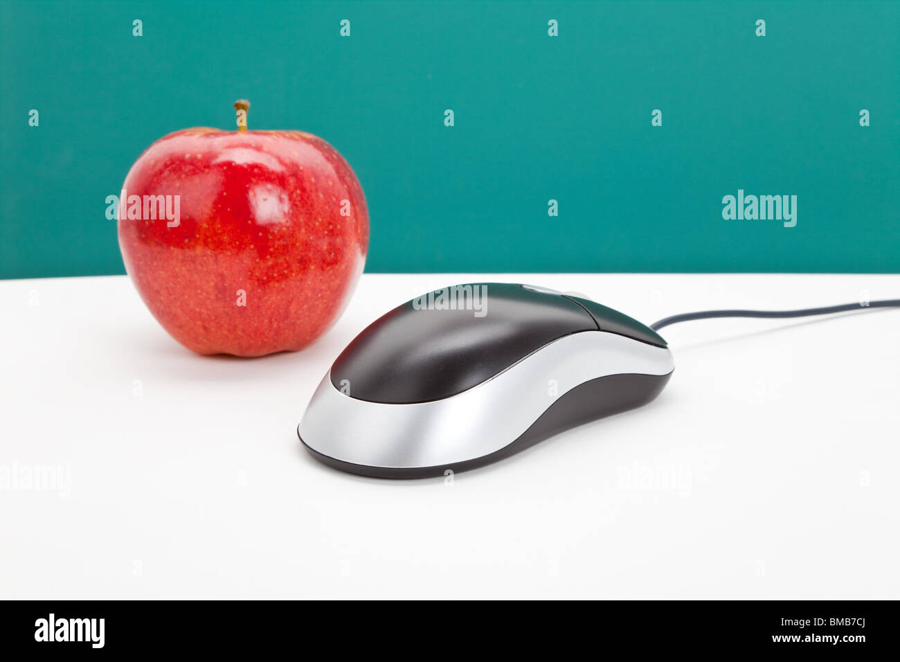 Computer Mouse and red apple close up Stock Photo - Alamy