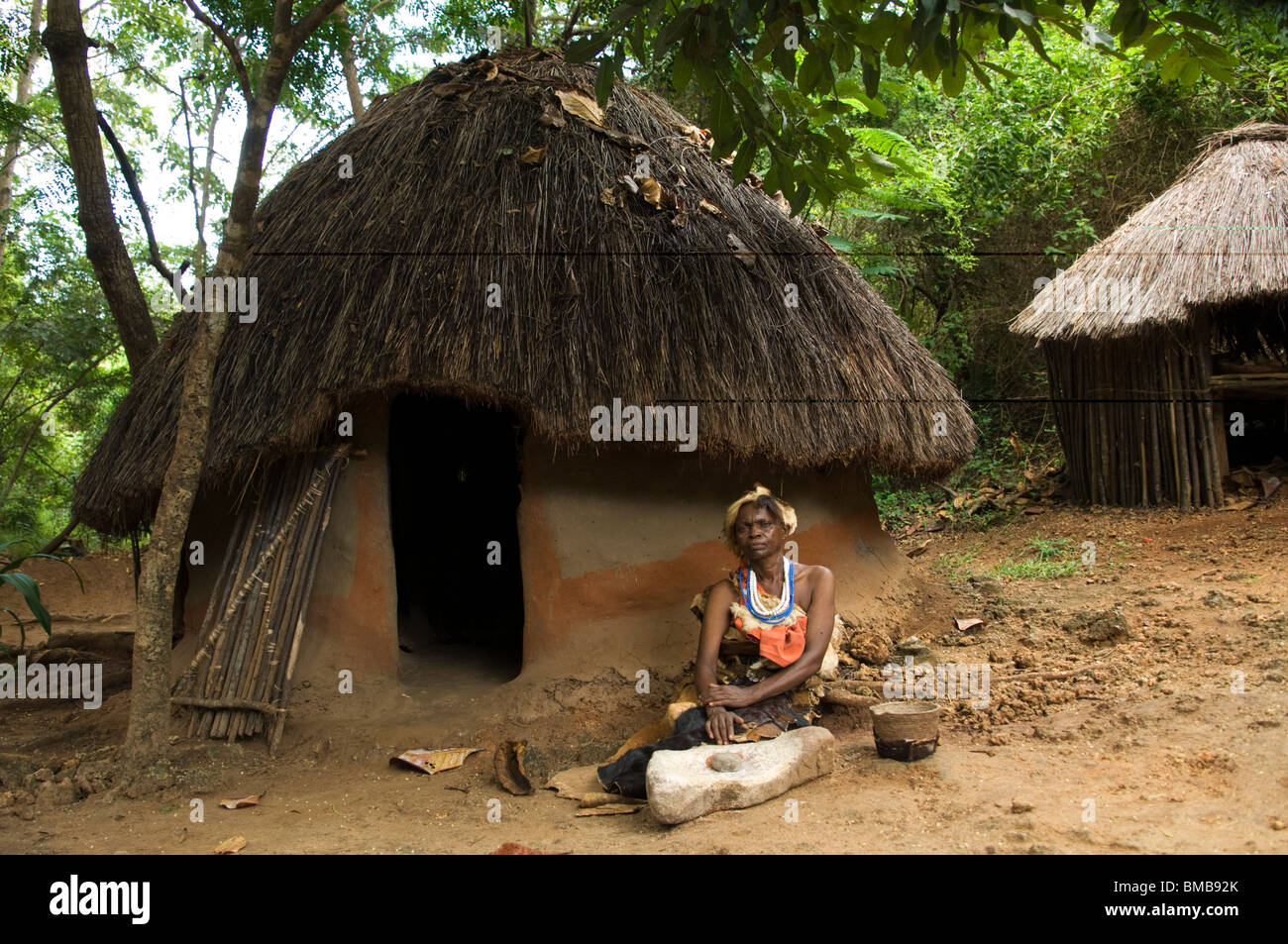 Kalenjin woman at her homestead grinding maize, Ngomongo village, Kenya ...