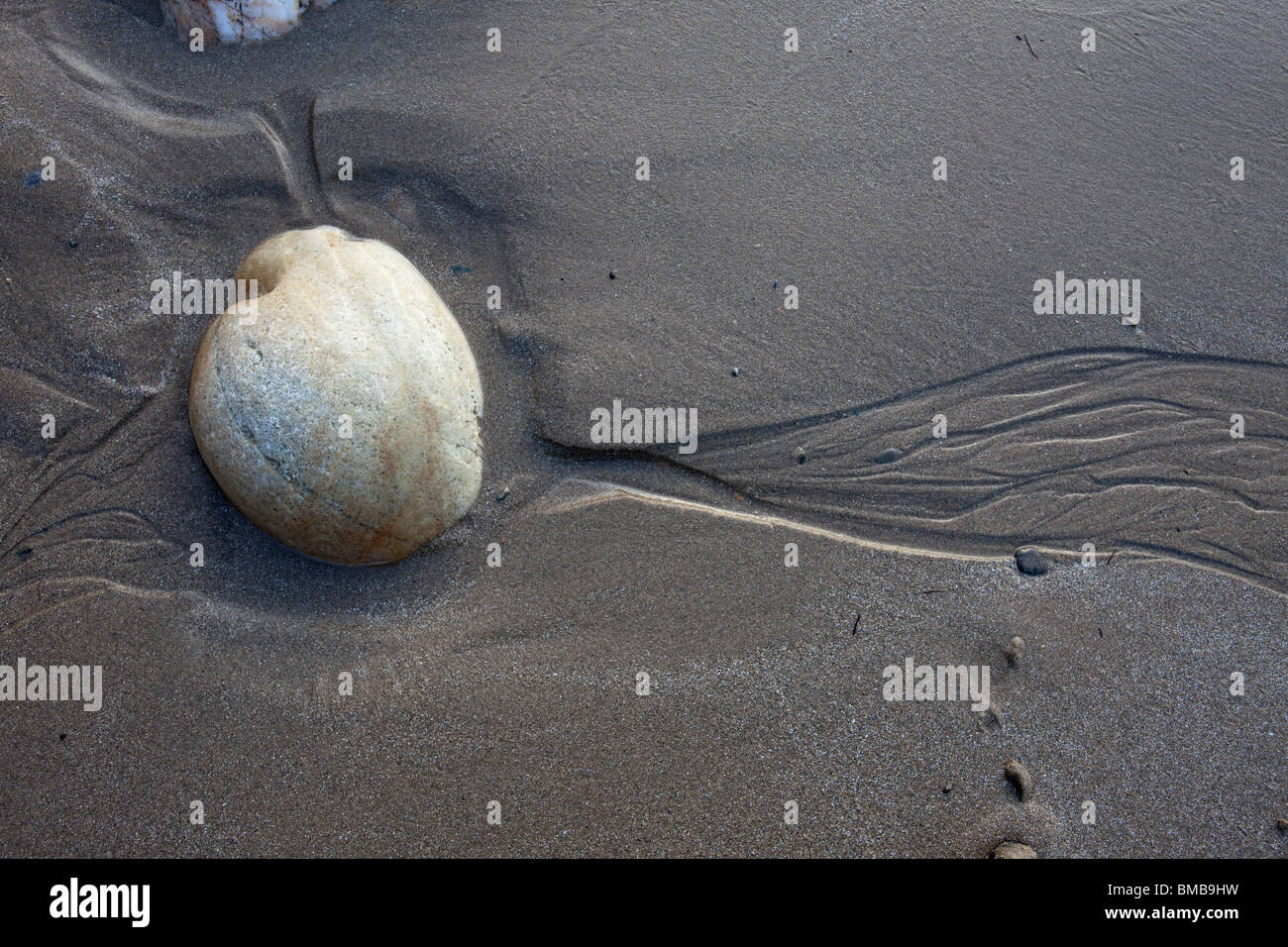 single pebble on beach Stock Photo - Alamy