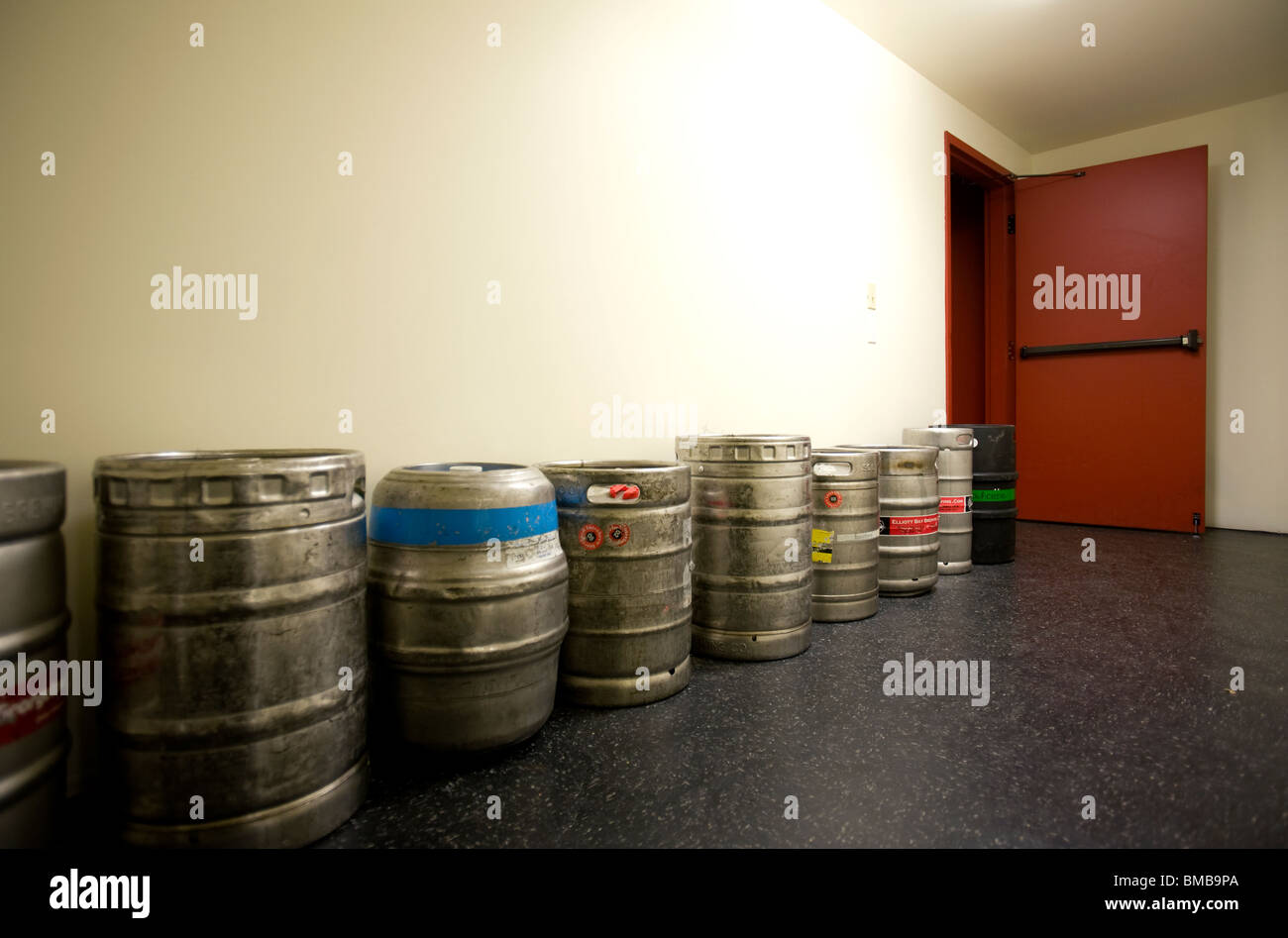 Beer kegs lined up by doorway Stock Photo - Alamy
