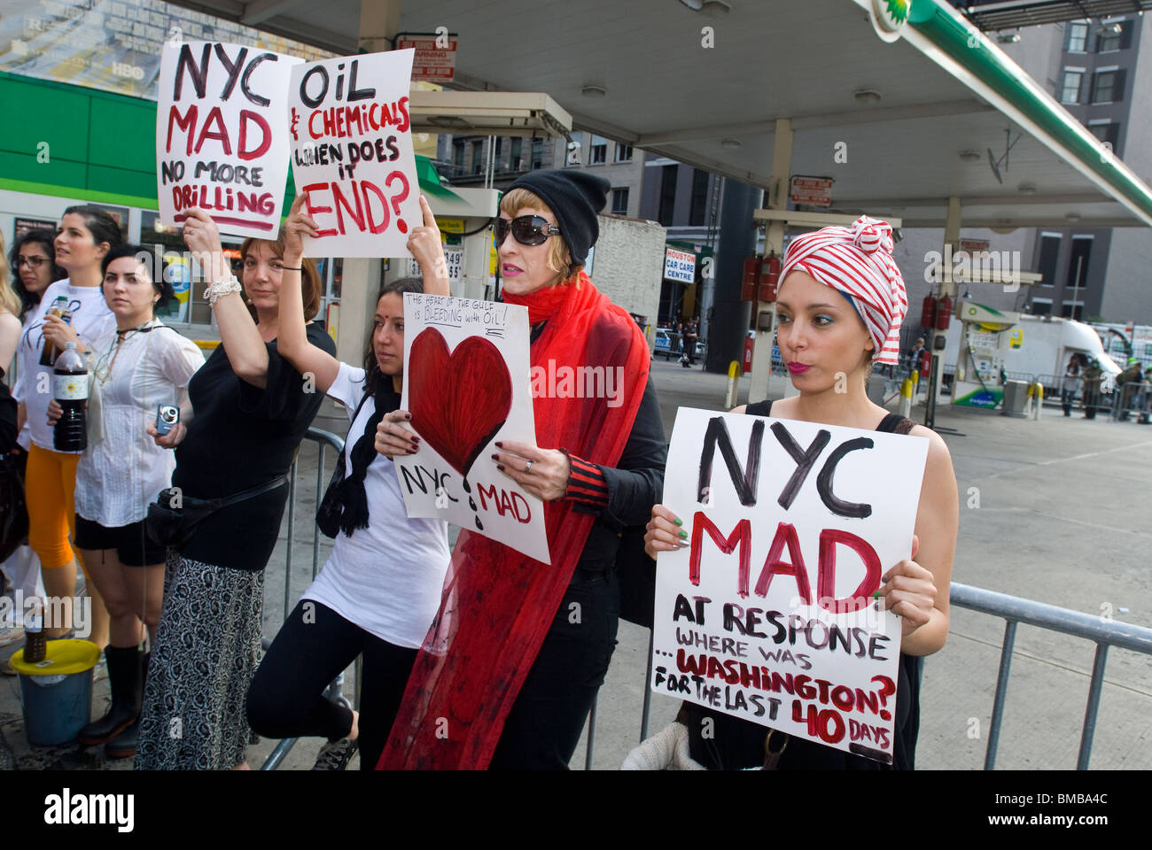 Protesters spill liquid representing oil over themselves in front of a ...