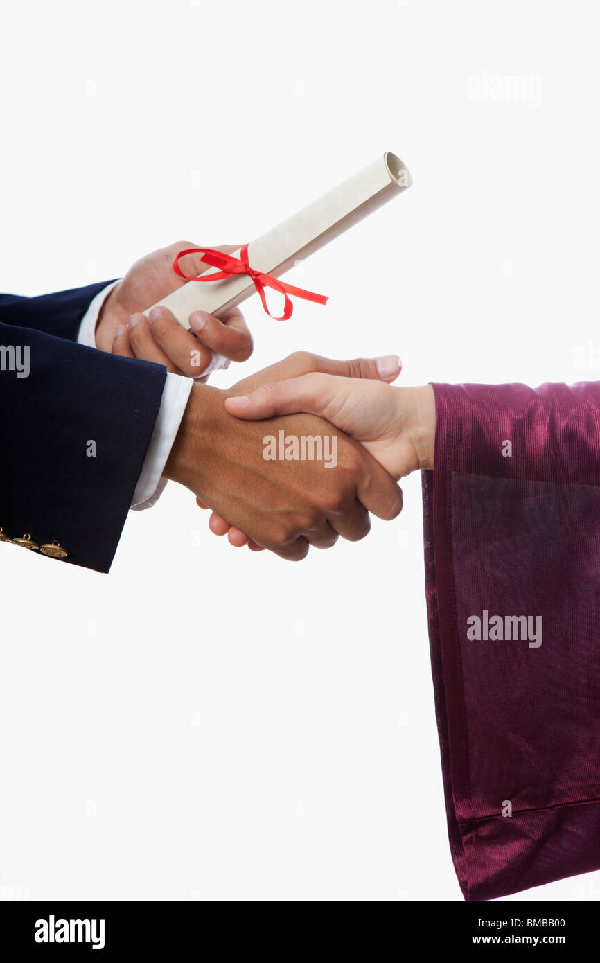 handshake and a diploma at graduation Stock Photo - Alamy