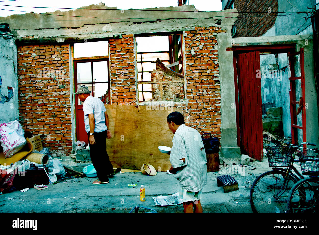 Chinese Men, Demolition in progress of historic houses in an area of ...