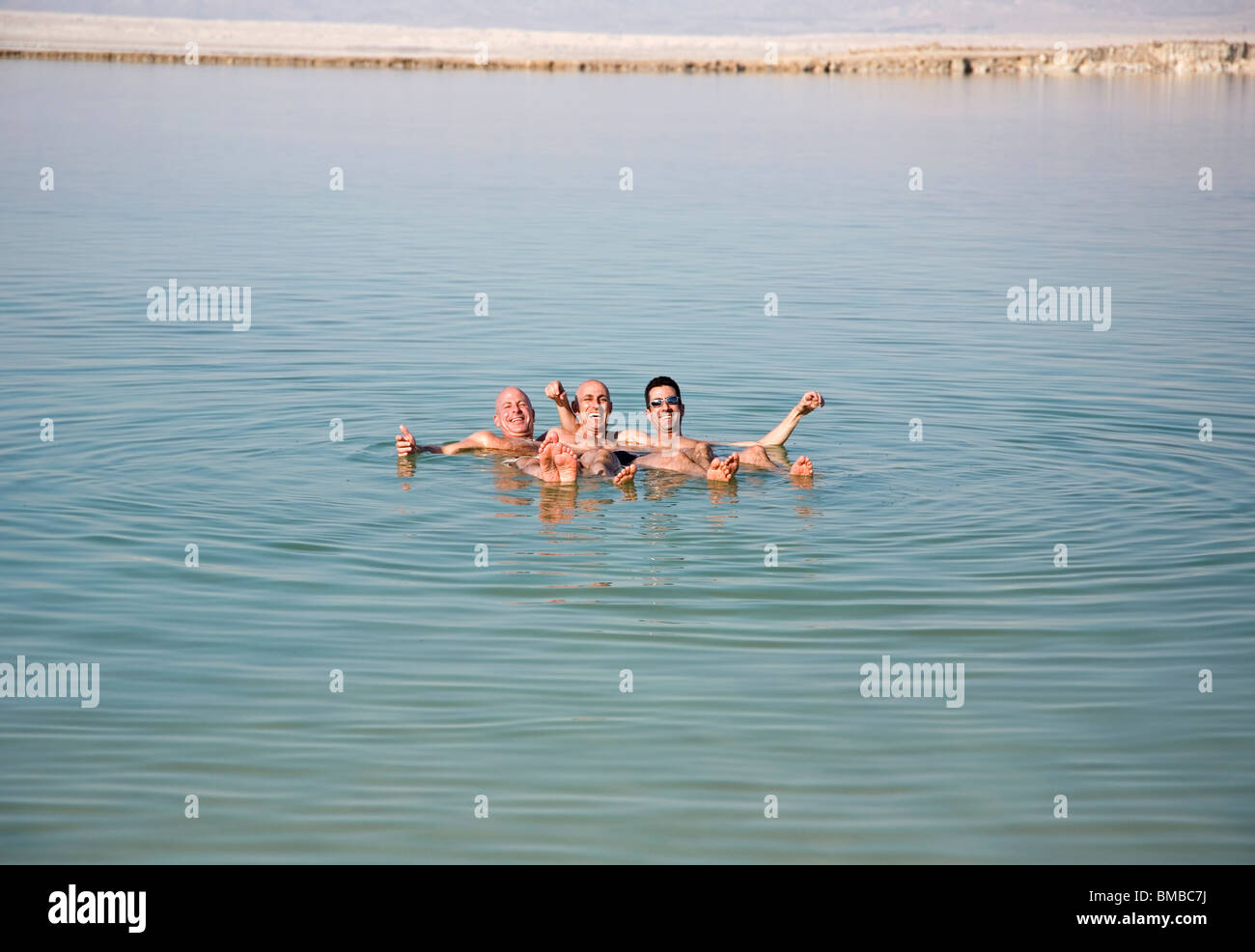 Three friends floating in the Dead Sea - Israel Stock Photo - Alamy