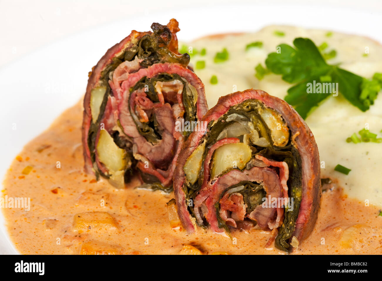 sliced rolled veal cutlets and a fork Stock Photo - Alamy