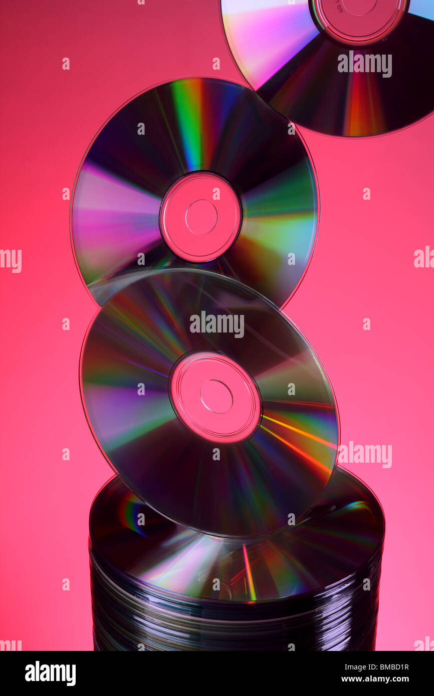 Photograph of cascading CDs on red background Stock Photo - Alamy