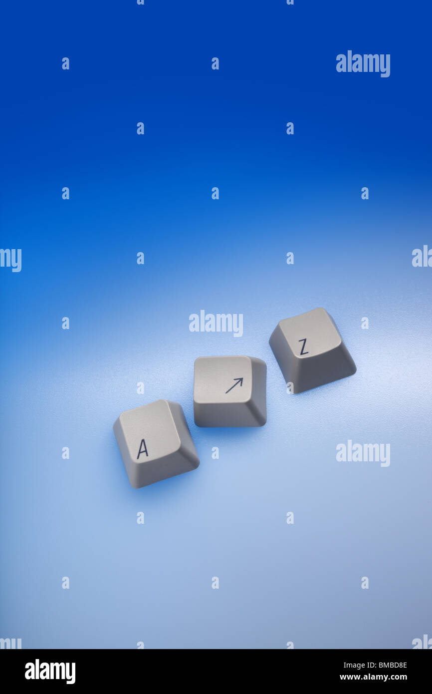 Three separate computer keys, A, arrow and Z, on a graduated blue ...