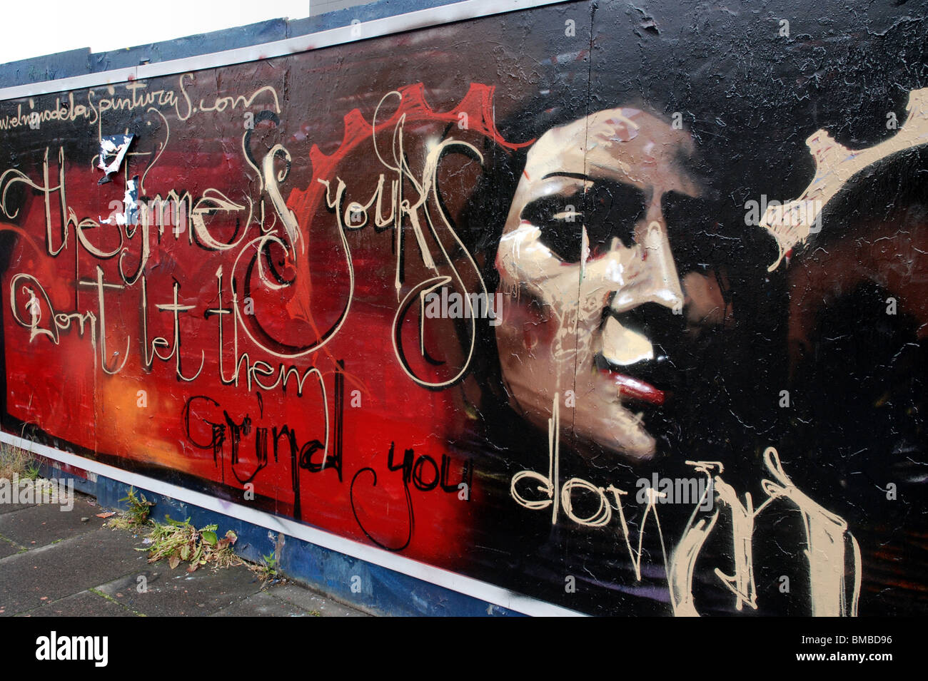 Graffiti with the words, "The time is yours, don't let them grind you ...