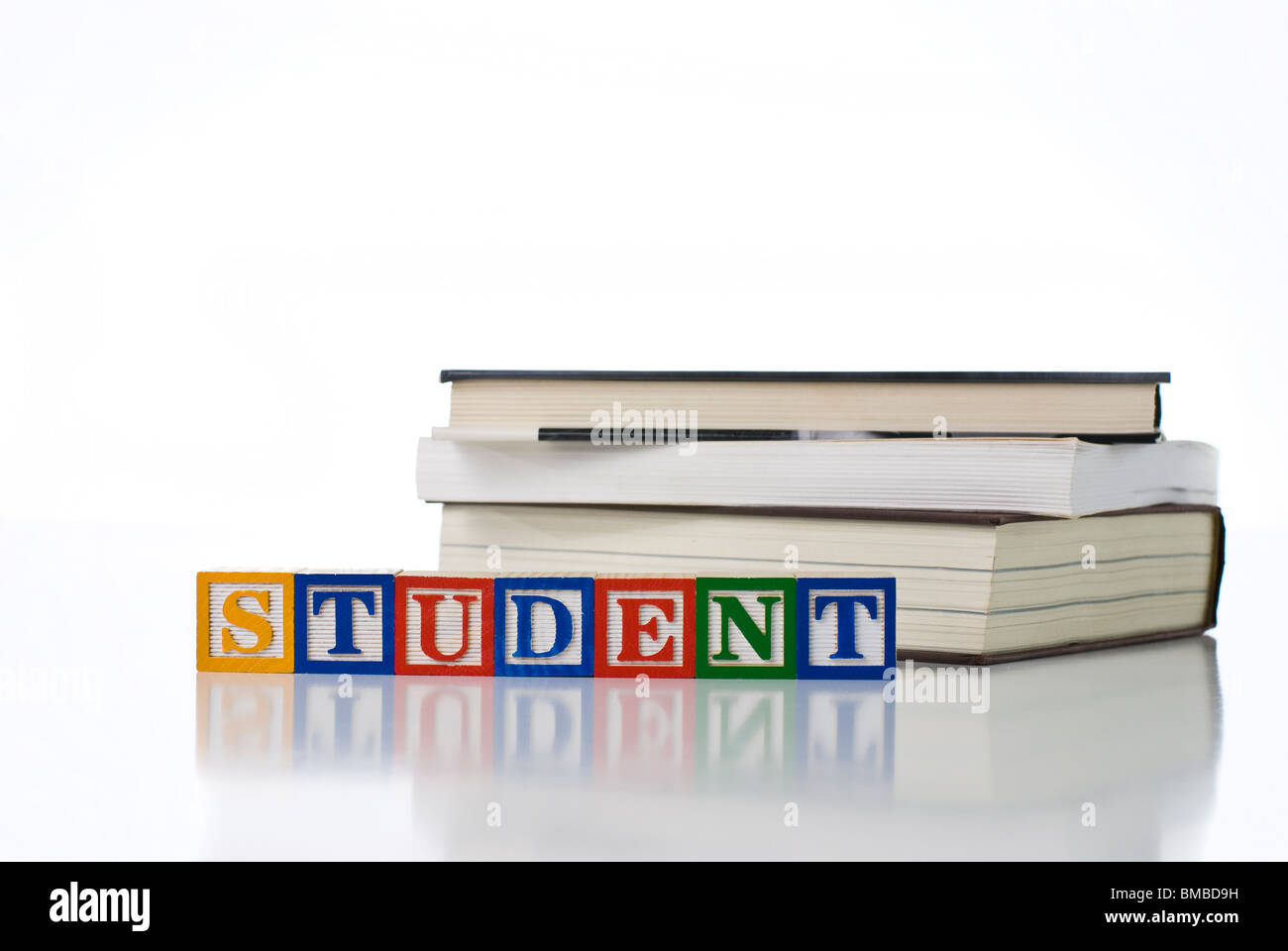 Colorful children's blocks spelling STUDENT with a stack of text books ...