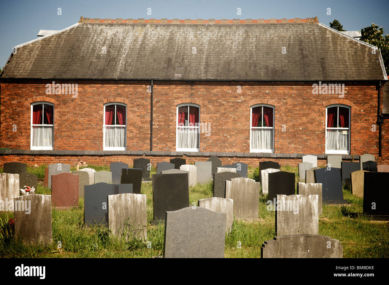 House windows overlooking graveyard Stock Photo - Alamy