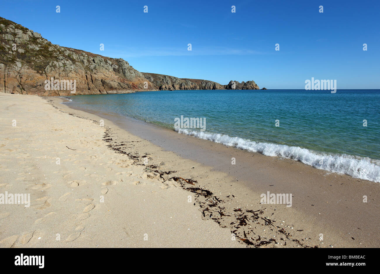 Porthcurno sandy beach shore line and Logan rock in Cornwall UK Stock ...