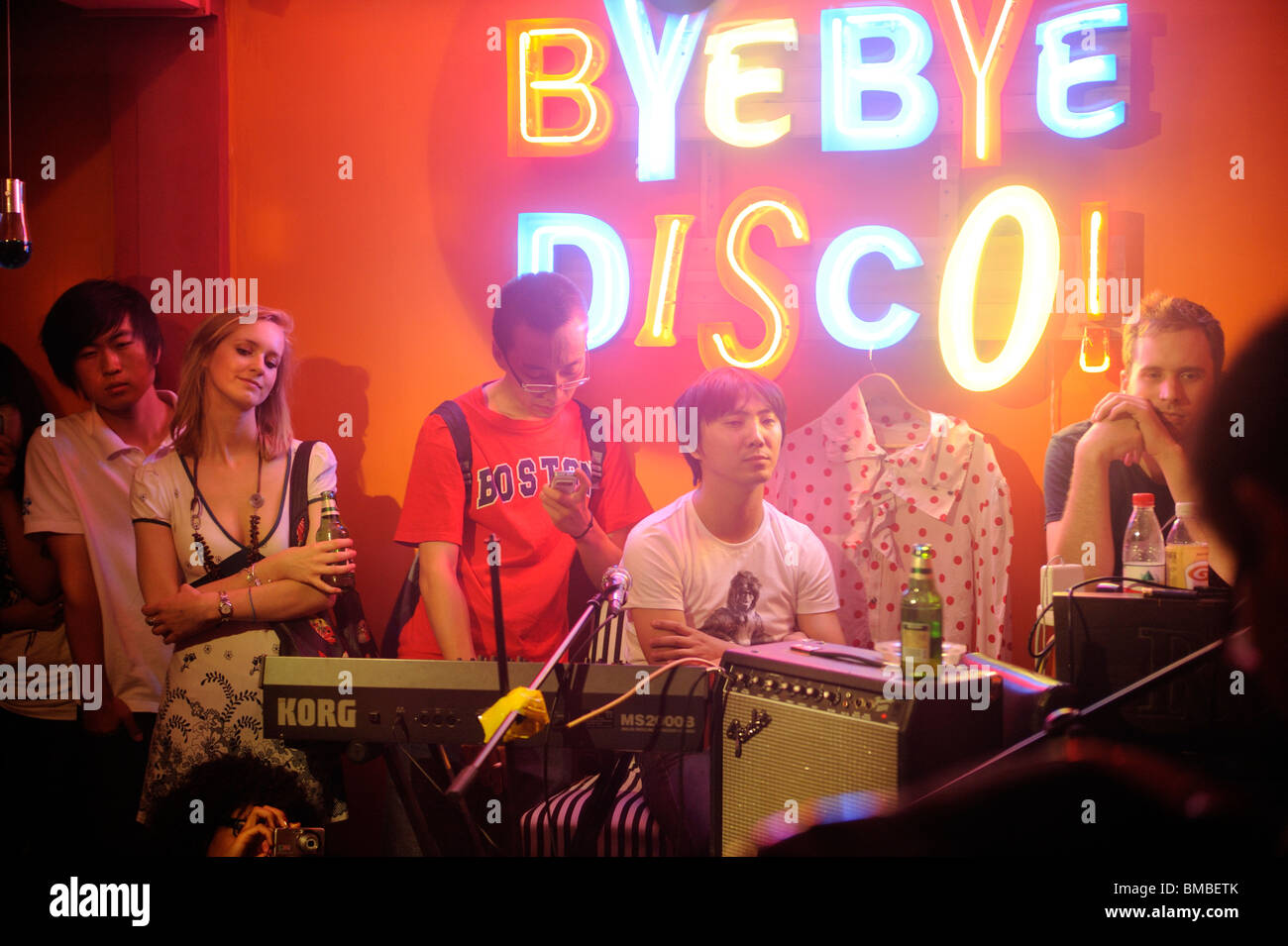 People listening folk music at a bar in Nan Luo Gu Xiang in Beijing ...