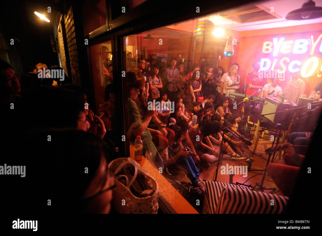 People listening folk music at a bar in Nan Luo Gu Xiang in Beijing ...