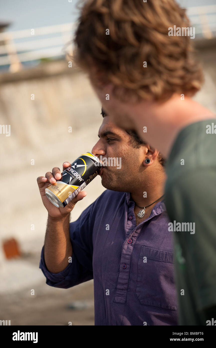 Young asian man drinking a can of cider outdoors, Summer afternoon ...