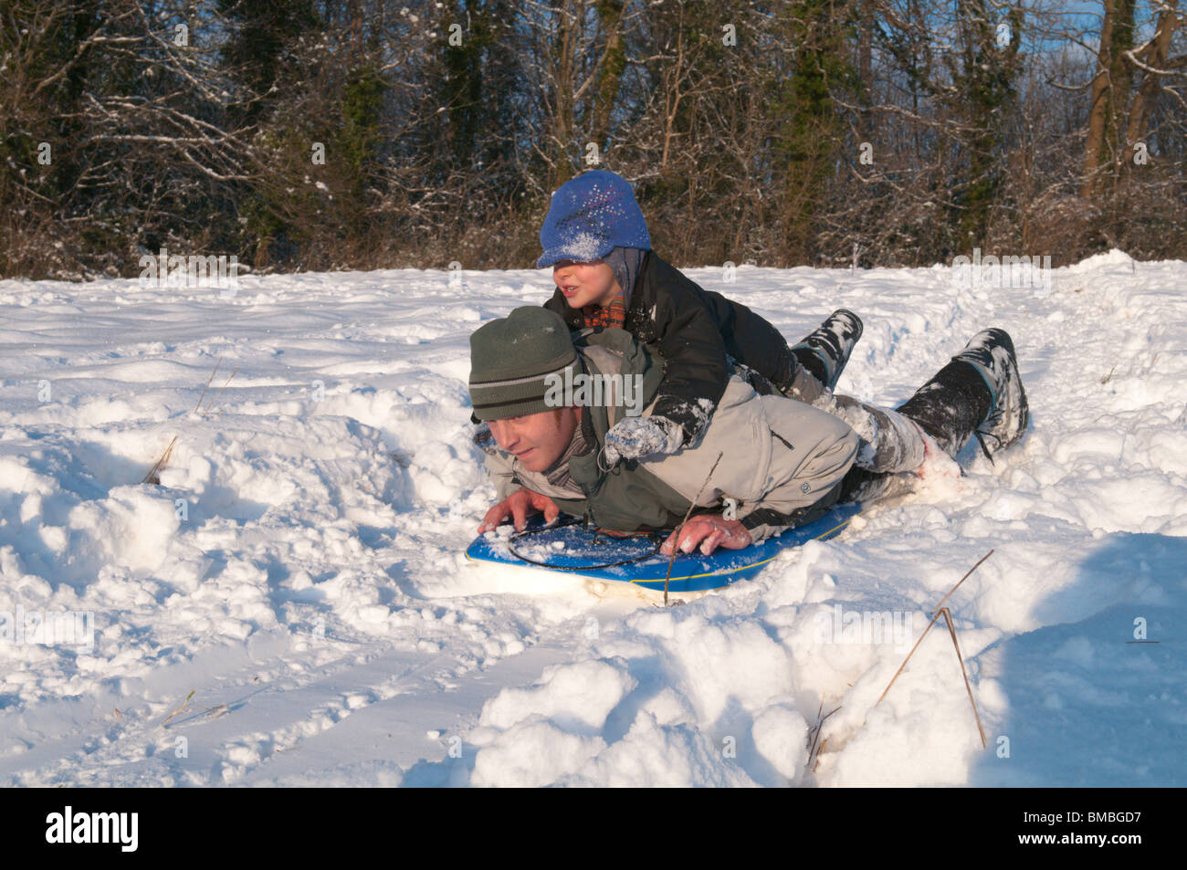 Family riding sledge hi-res stock photography and images - Alamy