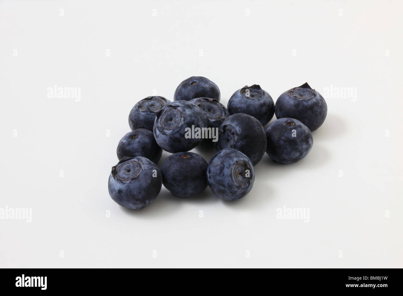 A pile of blueberries on white Stock Photo - Alamy